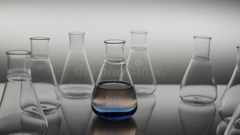 The Blue Liquid Spills Over Water in Laboratory Flask Stock Video ...