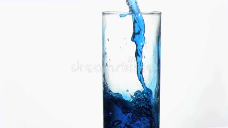Blue Liquid in Super Slow Motion Overflowing in a Glass Near Th Edge ...