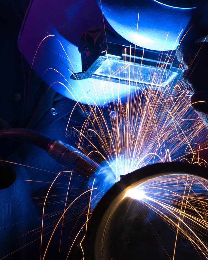 Blue lit MIG welder close stock image. Image of orange - 17363933