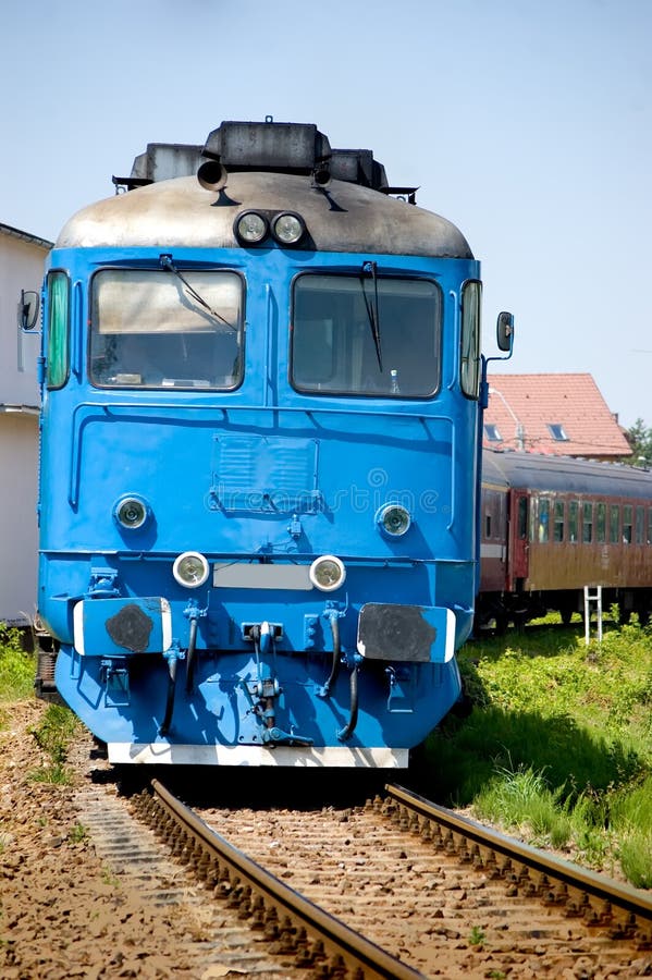 Old Blue Locomotive Standing on the Rails on the Background of Blue Sky ...