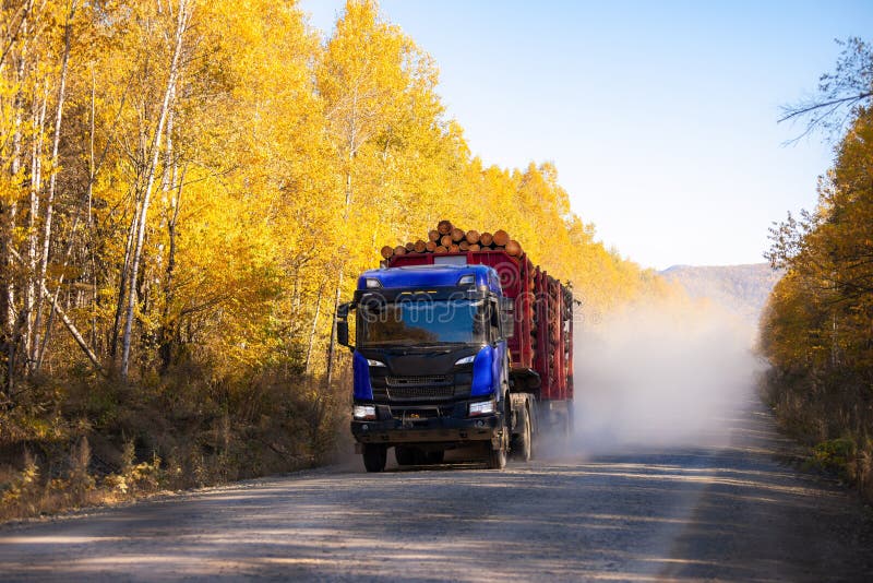 Blue Logging Truck on Forest Road in Autumn Editorial Stock Image ...