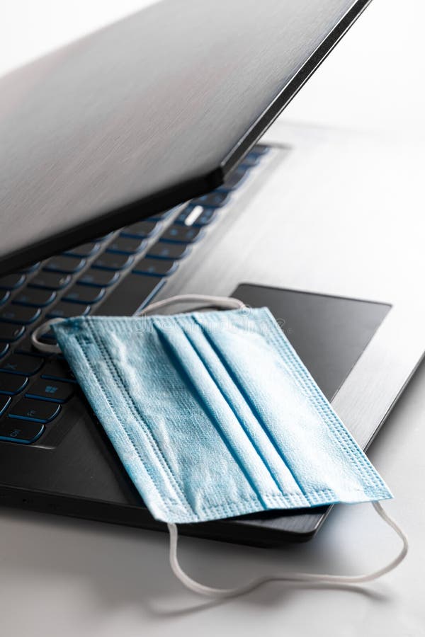 Blue Mask and Computer. Home Work during Coronavirus Pandemic Stock ...
