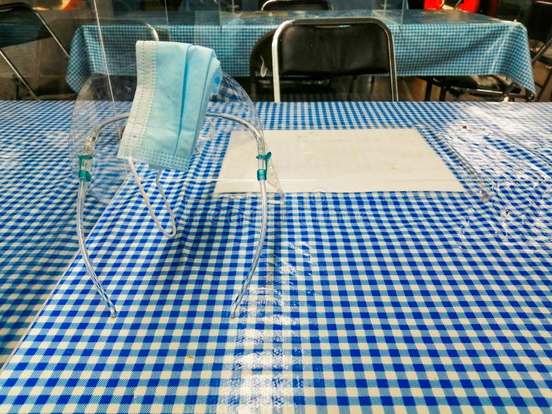 Blue Mask Folded Over Plastic Mask on a Table Stock Photo - Image of ...