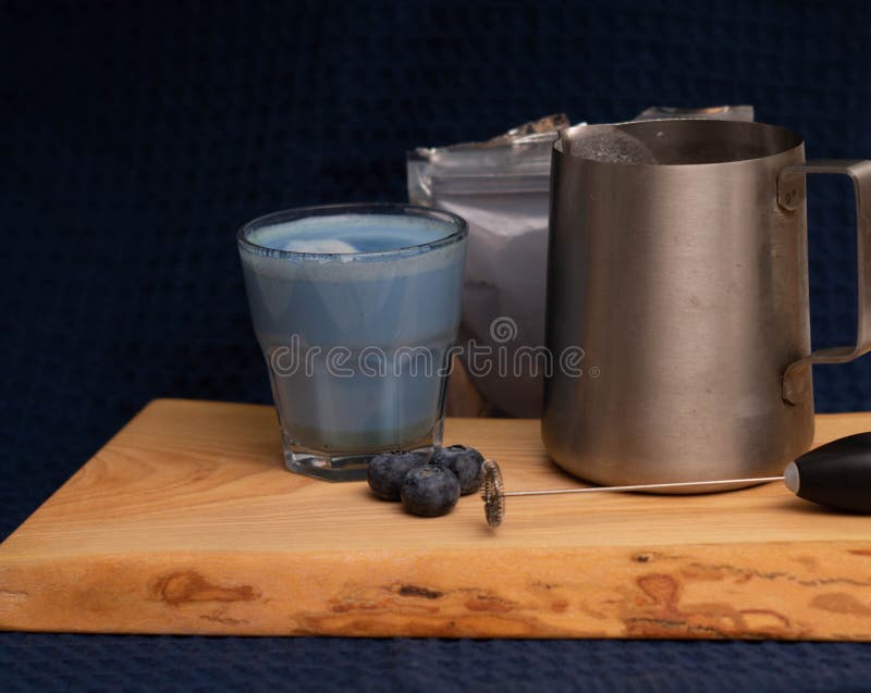 Blue Matcha Latte and Pitcher with Milk on Wooden Cutting Board. Still ...