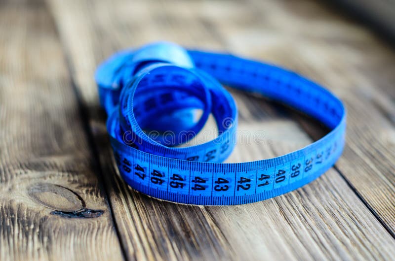 Blue Measuring Tape on Wooden Background Stock Image - Image of ...