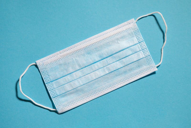 Blue Medical Face Mask on Blue Background Stock Image - Image of ...