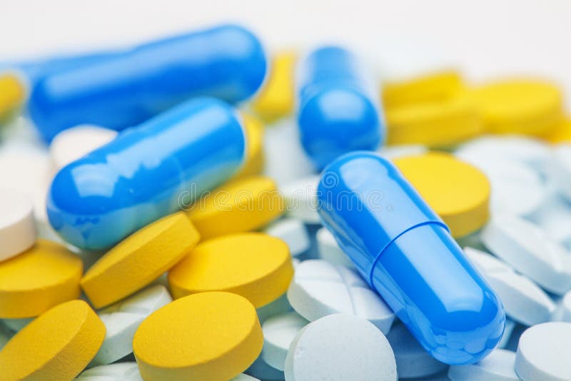 Blue Medical Pills on a Background of Different Color Tablets Stock ...