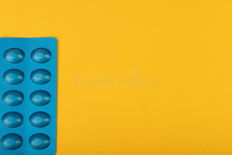 Blue Medication Blister Pack on Yellow Surface, Overhead Shot Stock ...