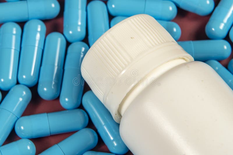 Blue Medicine Capsules and White Bottle Stock Image - Image of illness ...