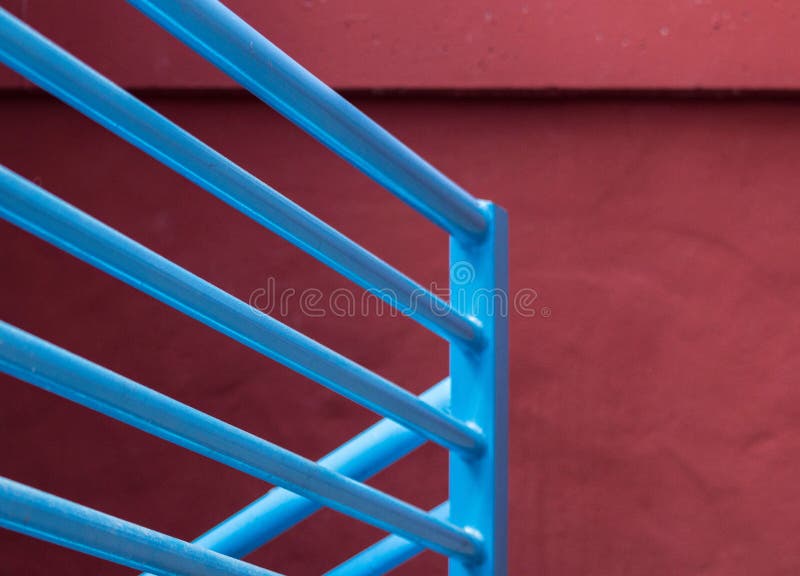 Blue Metallic Railing on the Staircase Near the Dark Red Wall Stock ...