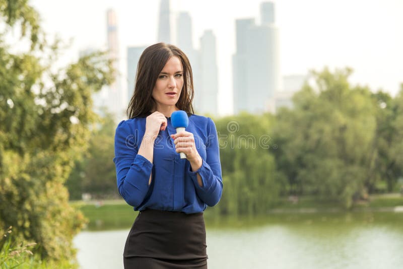 Reporter with a Microphone Wearing a Vest Stock Photo - Image of hand ...
