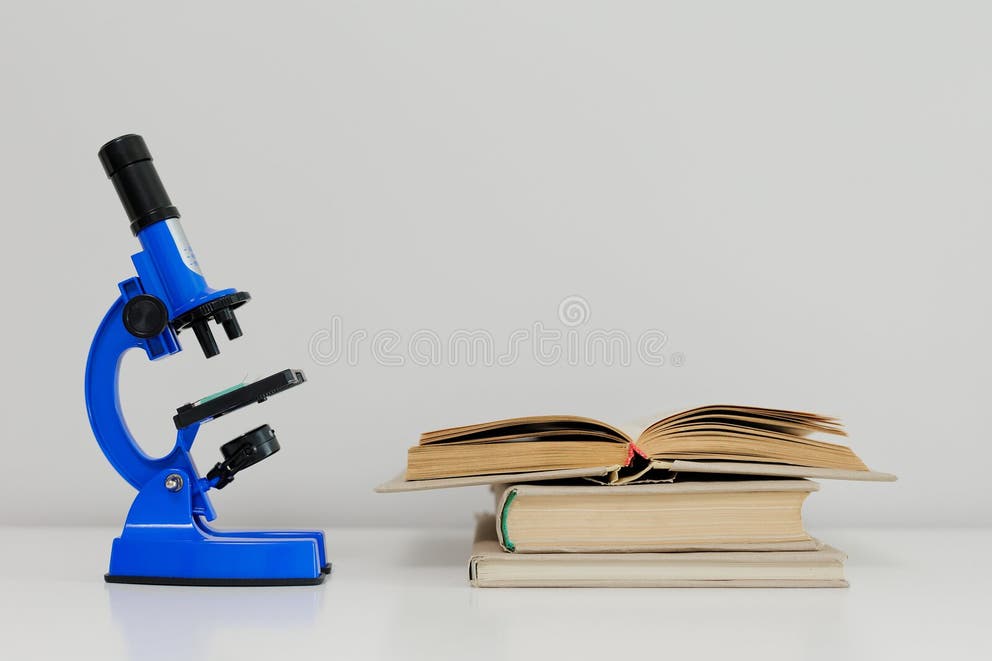 Blue Microscope and Books on Table Stock Image - Image of exercise ...