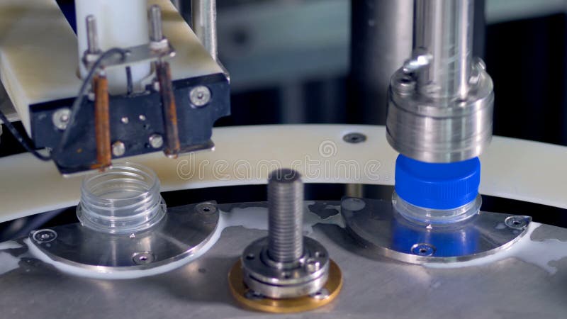 Blue Milk Bottle Caps are Twisted by a Factory Machine. Stock Footage ...