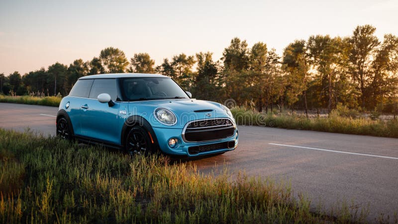 Blue Mini Cooper on Countryside Road at Sunset. Editorial Photography ...