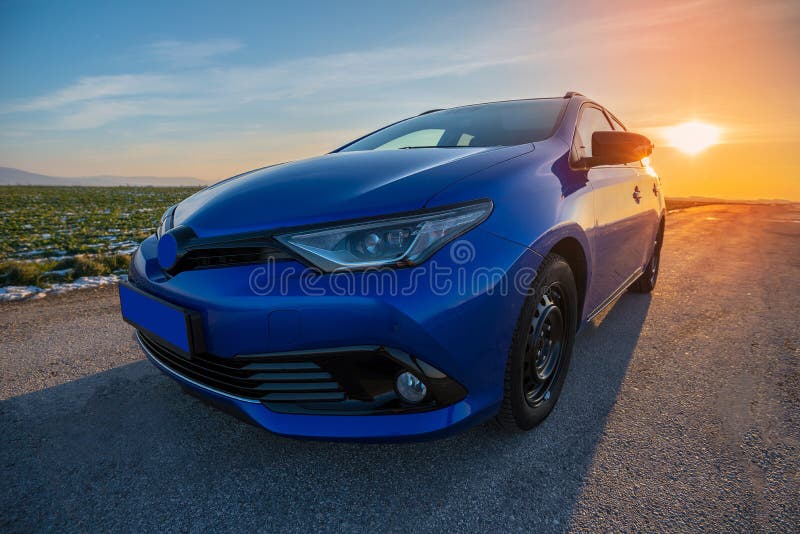 Blue Modern Hybrid Car at the Sunset. Front Side View Photo Stock Photo ...