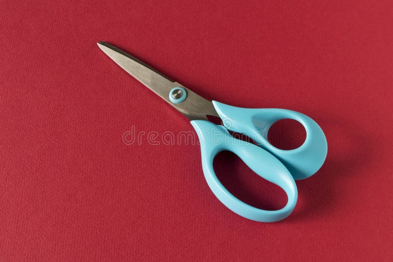 Blue Modern Scissors on a Red Background. Close Up Stock Photo - Image ...