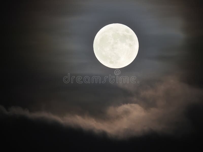 A Blue Moon Peaks Out from the Clouds and Mist Stock Image - Image of ...