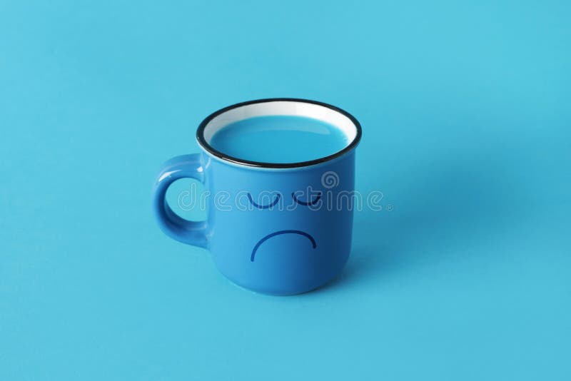 Blue mug with a sad face stock photo. Image of concept - 167485194