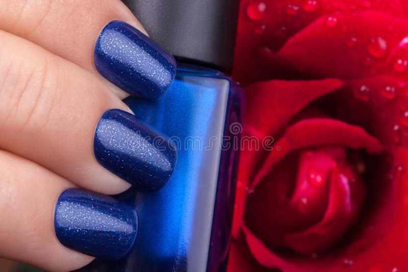 Blue nail polish. stock photo. Image of beauty, hands - 63230196