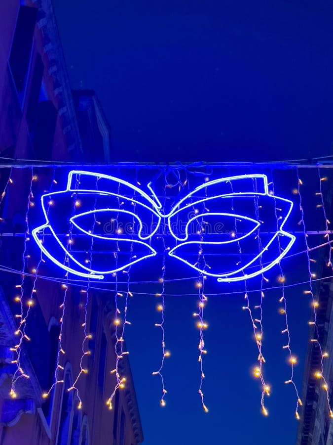 Blue Neon Carnival Mask with String Lights Illuminating Night Sky ...