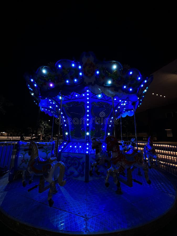 A blue neon carousel stock image. Image of waiting, scene - 262436399