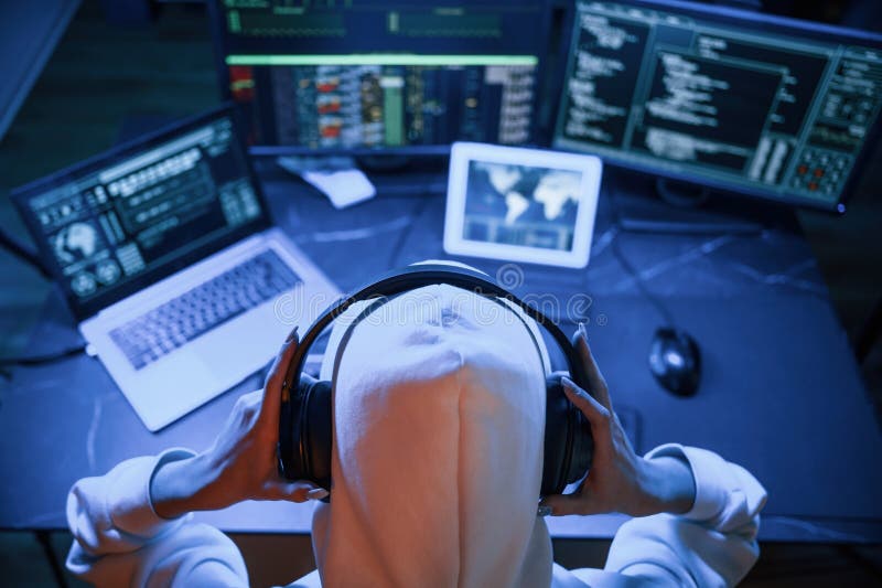 Blue Neon Light. Young Professional Female Hacker is Indoors by ...