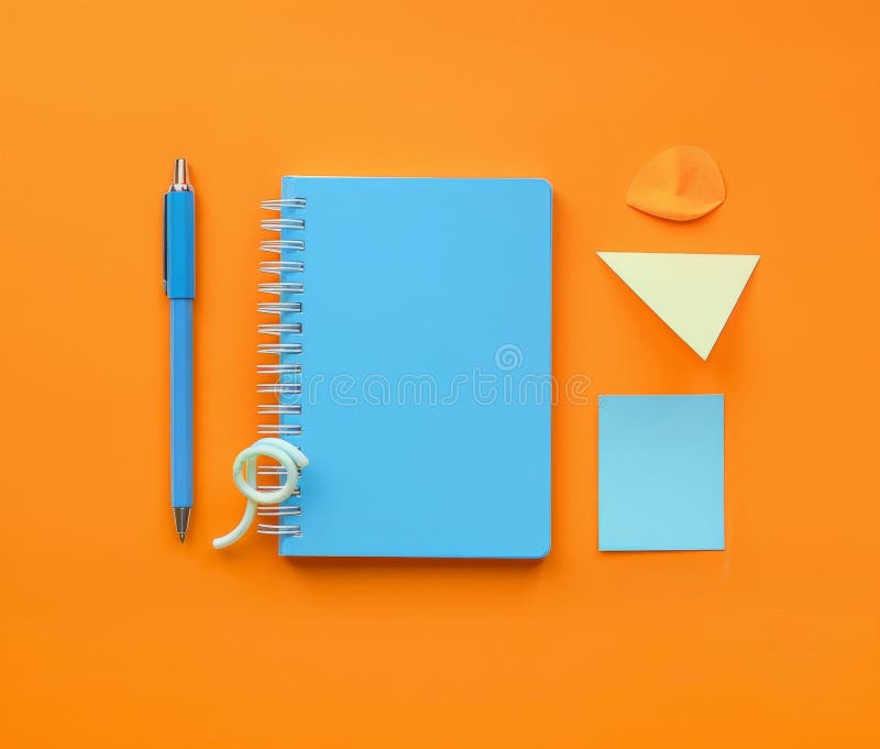 Blue Notebook with Post-it Notes and Pen on Vibrant Orange Background ...