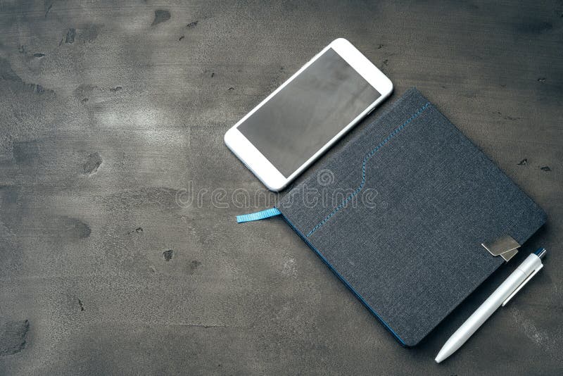 Blue Notepad, Smartphone and Pen on Dark Grey Table Stock Image - Image ...
