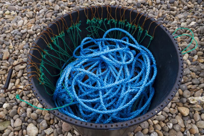 Blue Nylon Rope, Black Bin, Pebbled Beach Stock Photo - Image of string ...