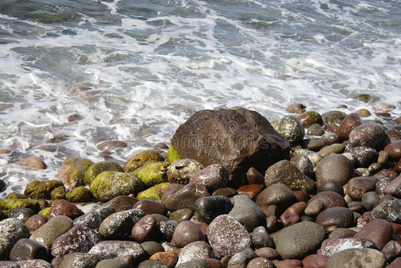 Blue Ocean and a Shoreline Filled with Rocks Stock Photo - Image of ...