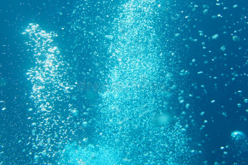 Blue Ocean Waves from Underwater with Bubbles. Light Rays Shining ...