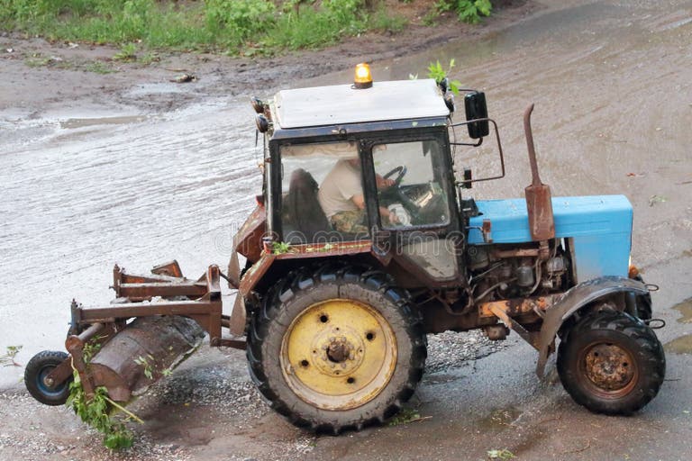 Blue Old and Rusty Tractor Running after Rain Storms Stock Image ...