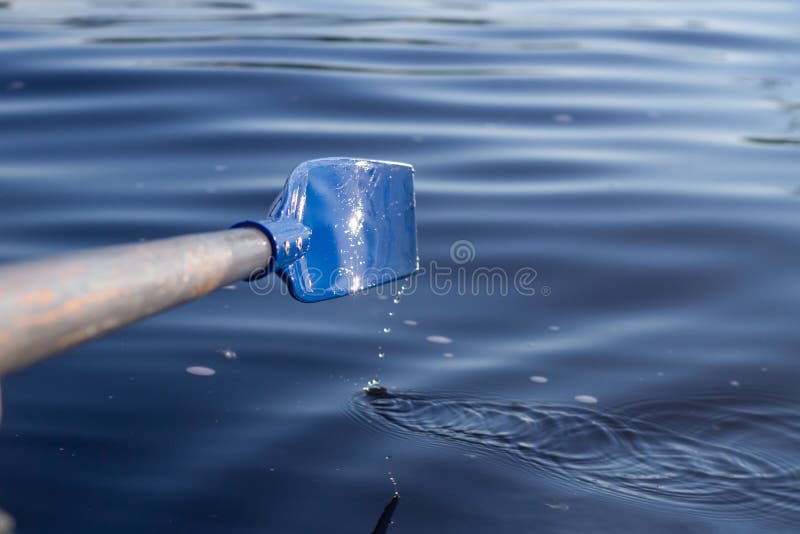 The Blue Paddle from the Boat Was Rowing the Water Stock Photo - Image ...