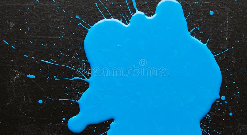 Blue Paint Splatter Across a Black Surface Creates a Vivid Contrast ...