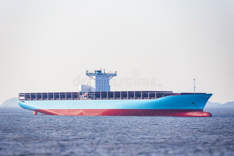 Blue Painted Cargo Container Ship Anchored Near Coastline. Stock Image ...