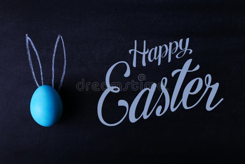 A Blue Painted Easter Egg on a Chalkboard with Pressed Ears Looks Like ...