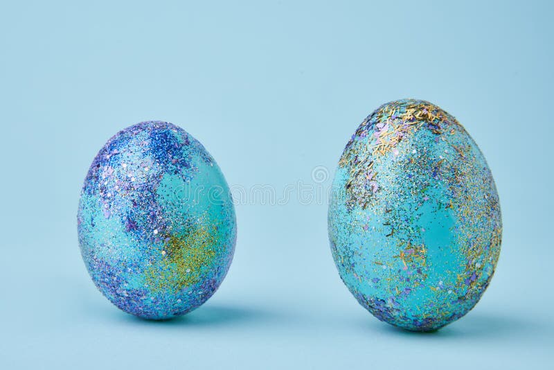 Blue Painted Eggs with Bright Shiny Gliter on Blue Background Stock ...