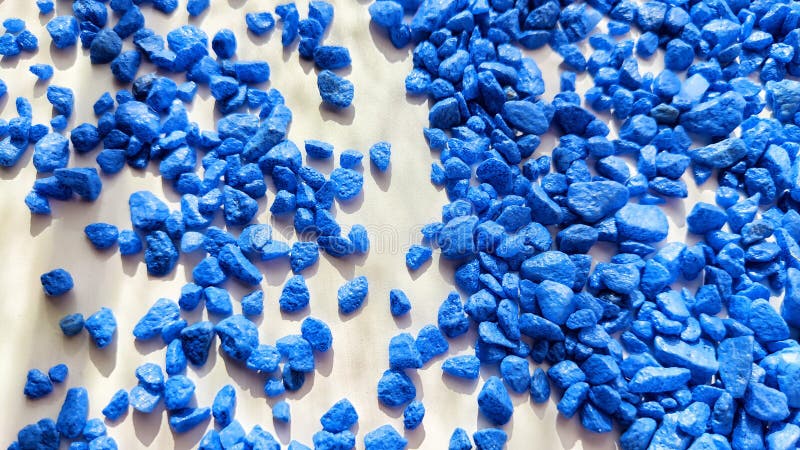 Blue Painted Small Pebble on the Surface of a Table Under Sunlight ...