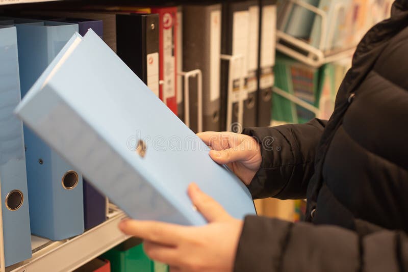 Blue paper folder in hand stock image. Image of meeting - 205331897