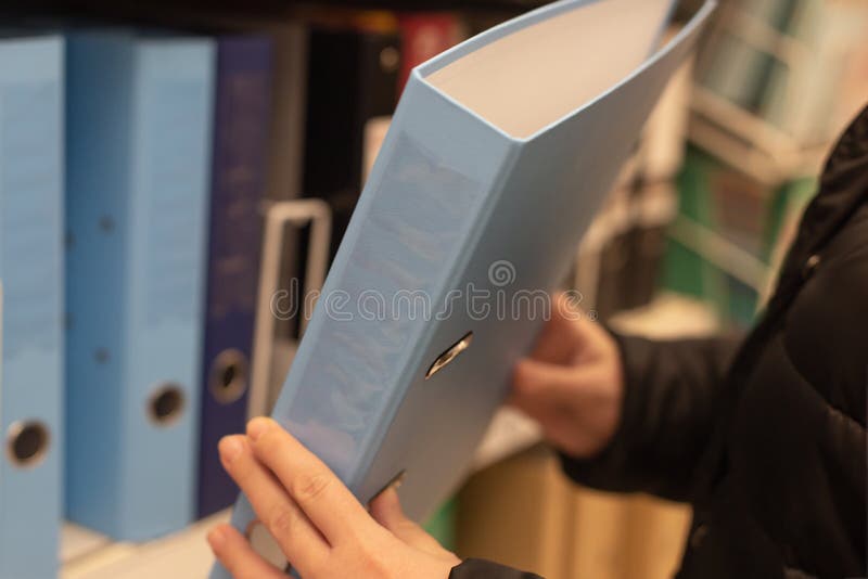 Blue paper folder in hand stock image. Image of human - 205468981