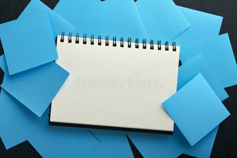 Blue Paper Stickers and Notepad or Book in Middle on Black Background ...