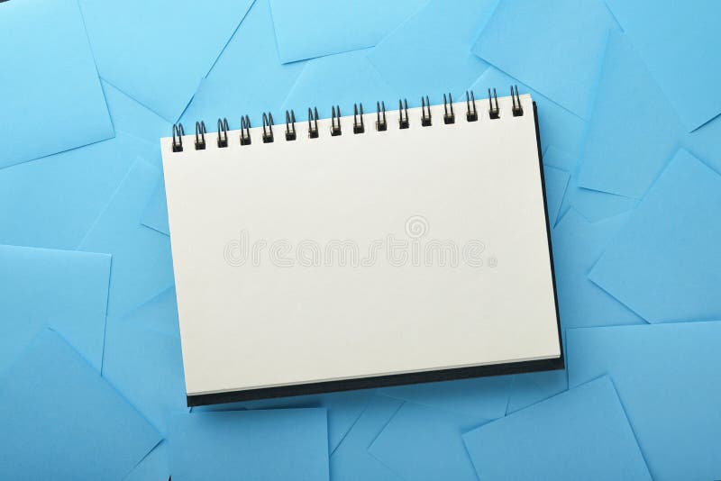 Blue Paper Stickers and Notepad or Book in Middle on Black Background ...