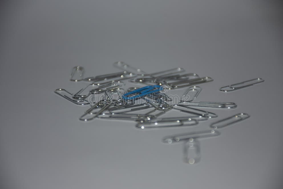Blue Paperclip Different from Others Stock Photo - Image of closeup ...