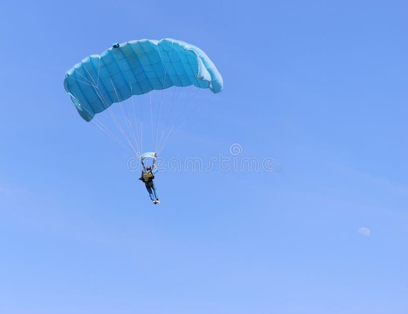 Blue Parachute Folded Up on the Ground Stock Image - Image of parachute ...