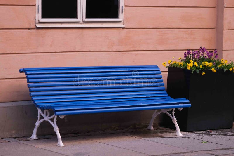 A blue park bench stock image. Image of decoration, flowers - 379863791
