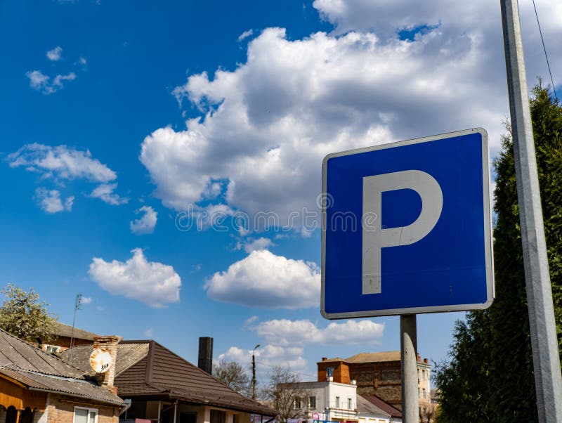 A Blue Parking Sign Sitting on the Side of a Road Stock Photo - Image ...