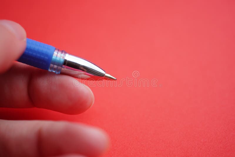 Blue Pen in Female Fingers on Red Paper Stock Image - Image of notepad ...