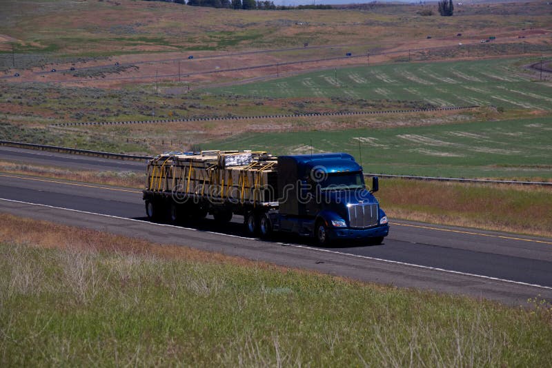 Blue Peterbilt / Loaded Flatbed Stock Photo - Image of tractor, driving ...