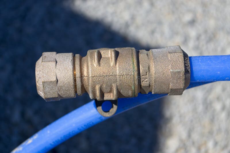 Blue PEX Pipe with Brass Shut Off Fitting on the End.Taken at a ...