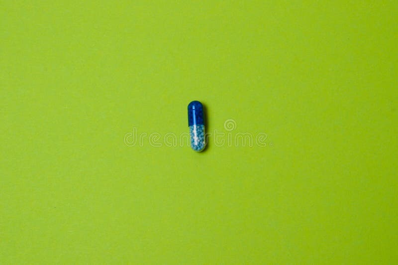 Blue Pill on a Green Background, Isolate, with Place for Text Stock ...